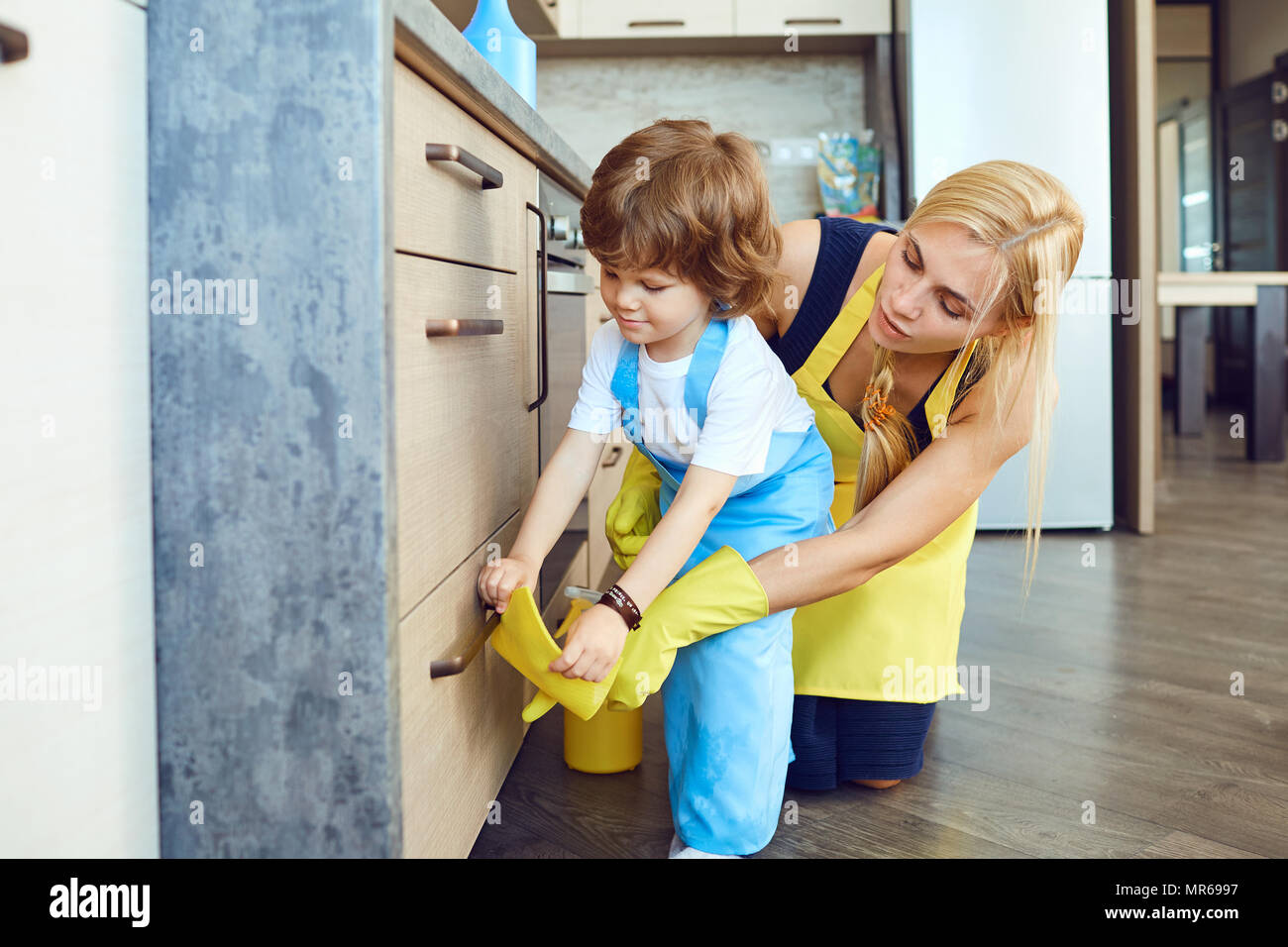 Mom and child are cleaning the house Stock Photo - Alamy