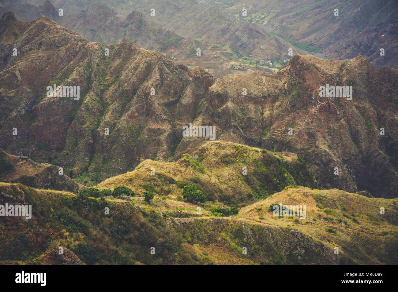 Overview of vertiginous mountains ridge with some dwellings, valleys ...