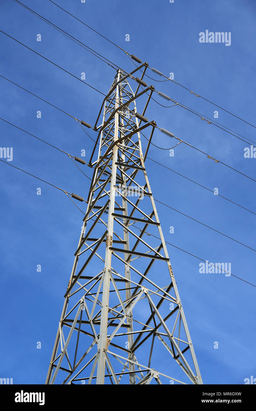 Electric tower view from below under blue sky Stock Photo - Alamy