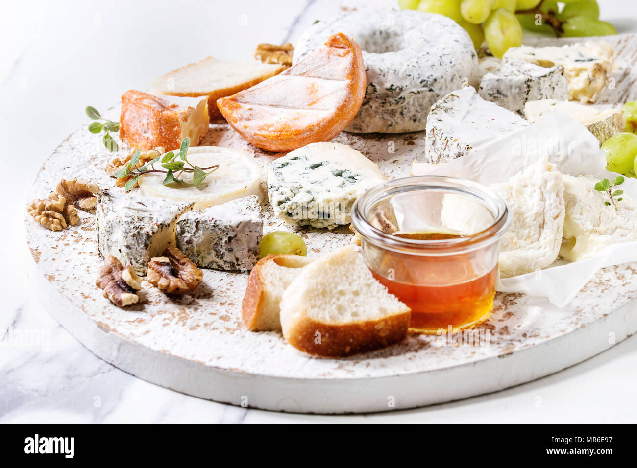 Cheese plate assortment of french cheese served with honey, walnuts ...