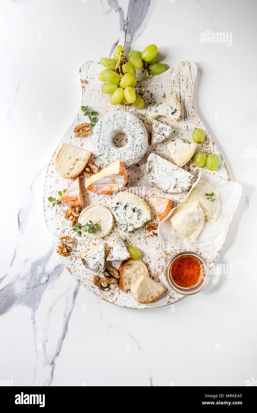 Cheese plate assortment of french cheese served with honey, walnuts ...
