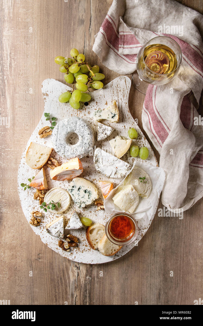 Cheese plate assortment of french cheese served with honey, walnuts ...