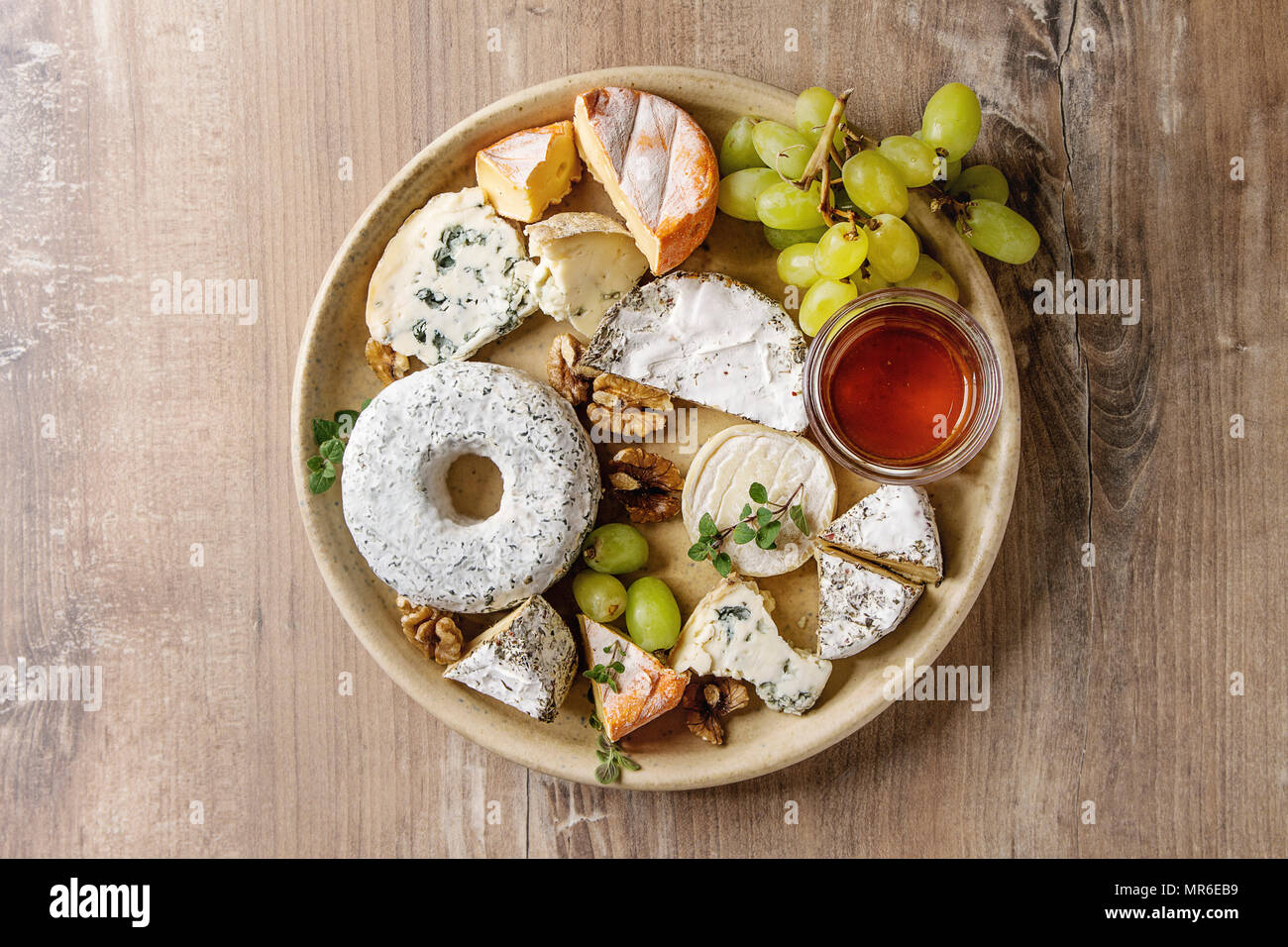 Cheese plate assortment of french cheese served with honey, walnuts ...