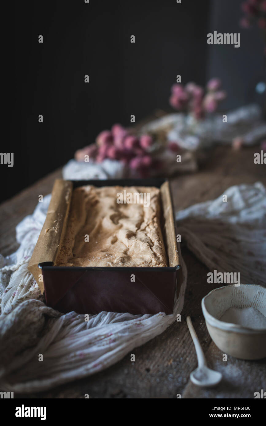 A sponge cake on a rustic kitchen table Stock Photo - Alamy