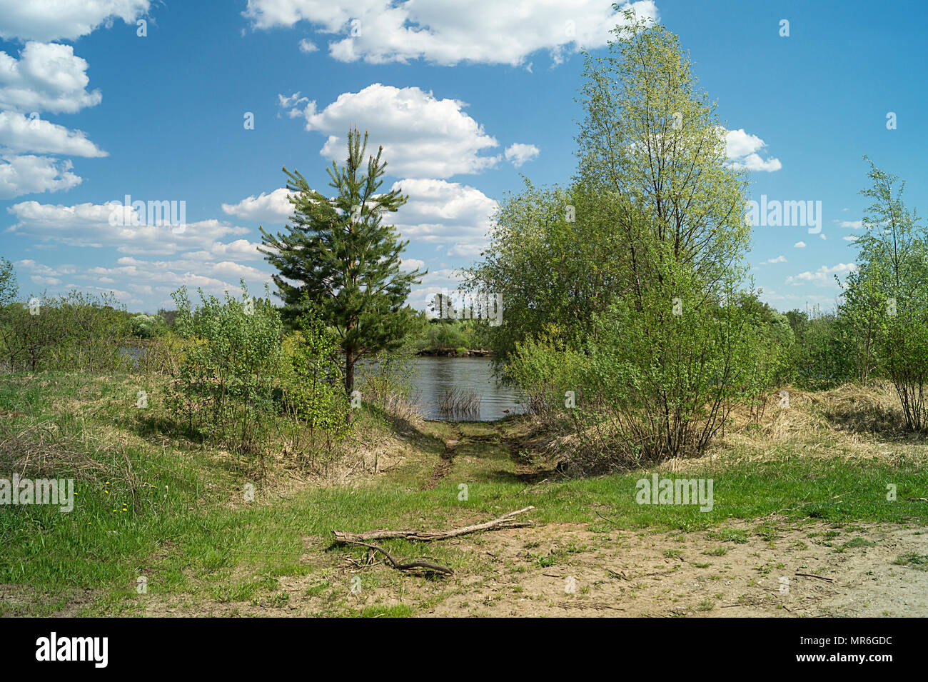 Spring landscape with river in rural terrain on background blue sky ...