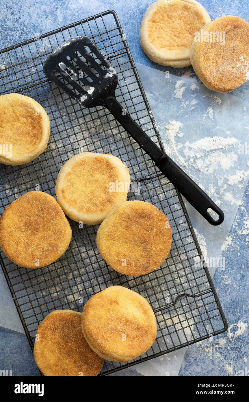 English muffins cooling on a wire rack with a lifter Stock Photo - Alamy