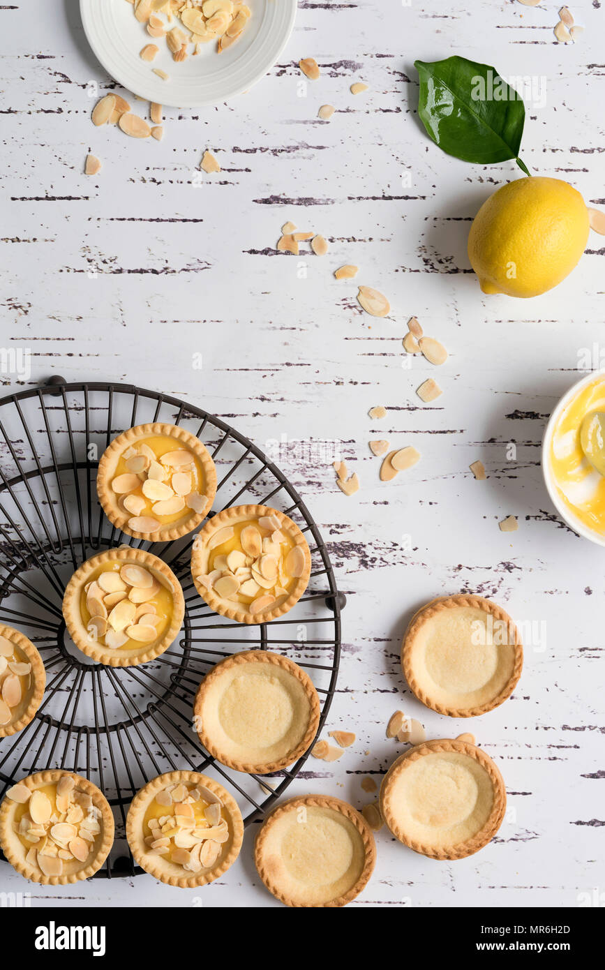 Small round pastry cases unfilled and filled with lemon butter and ...