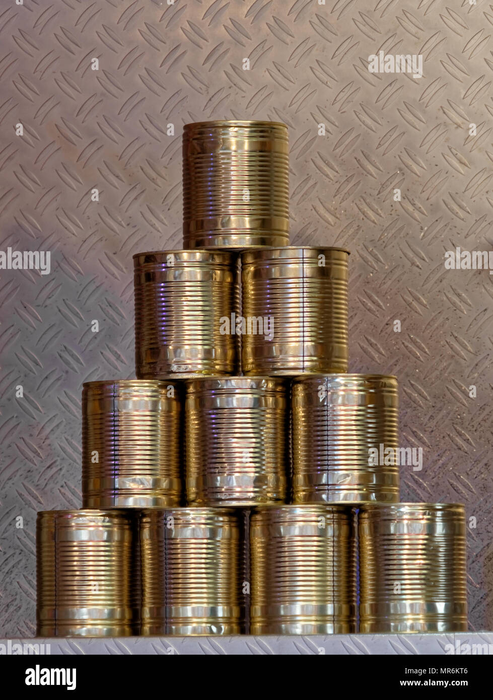 Pyramid of ten tin cans without banderole, which are put together at ...