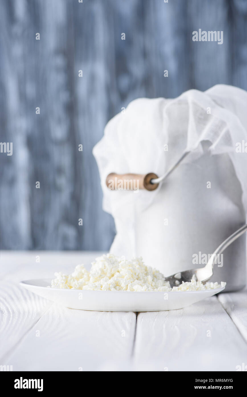 delicious healthy cottage cheese and metal bucket behind on wooden ...