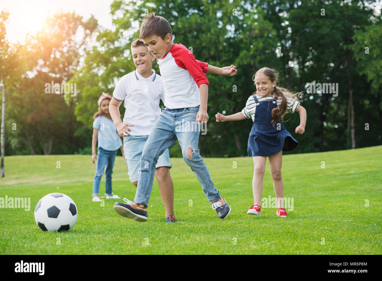 Kids Playing Soccer In The Park