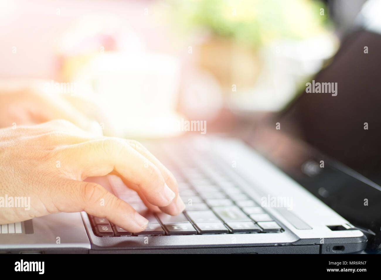 Businessman typing on keypad at coffee shop Stock Photo - Alamy