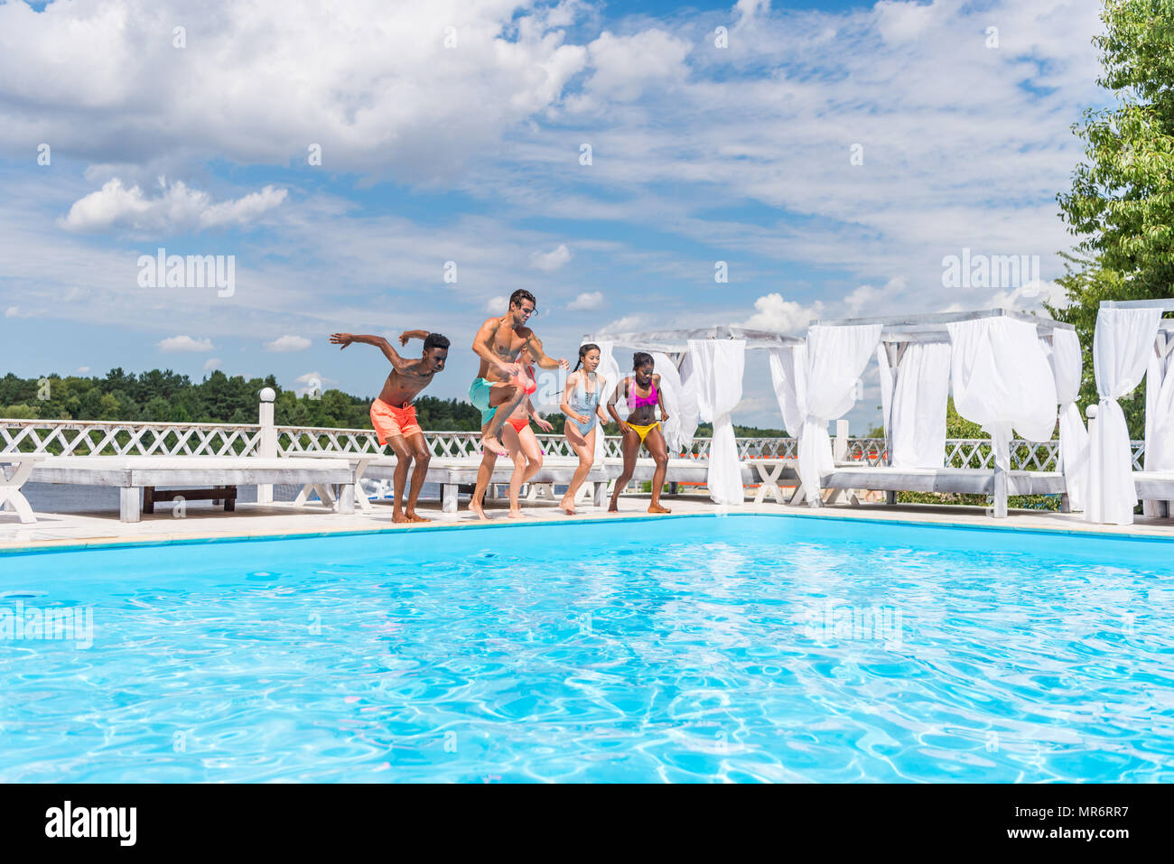Young Women And Jumping Into Pool Stock Photos & Young Women And ...