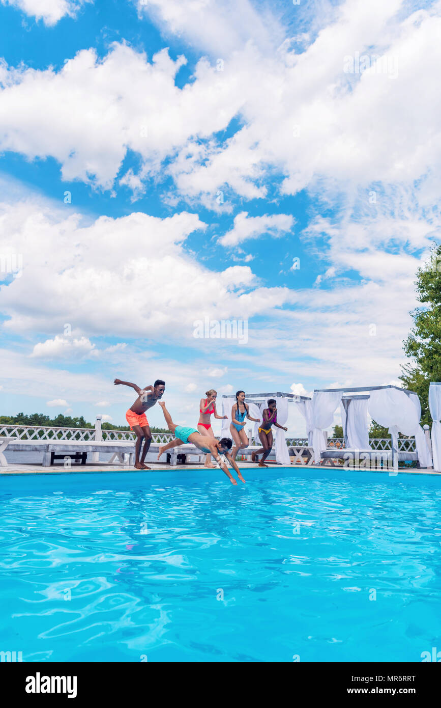 Young Women And Jumping Into Pool Stock Photos & Young Women And ...