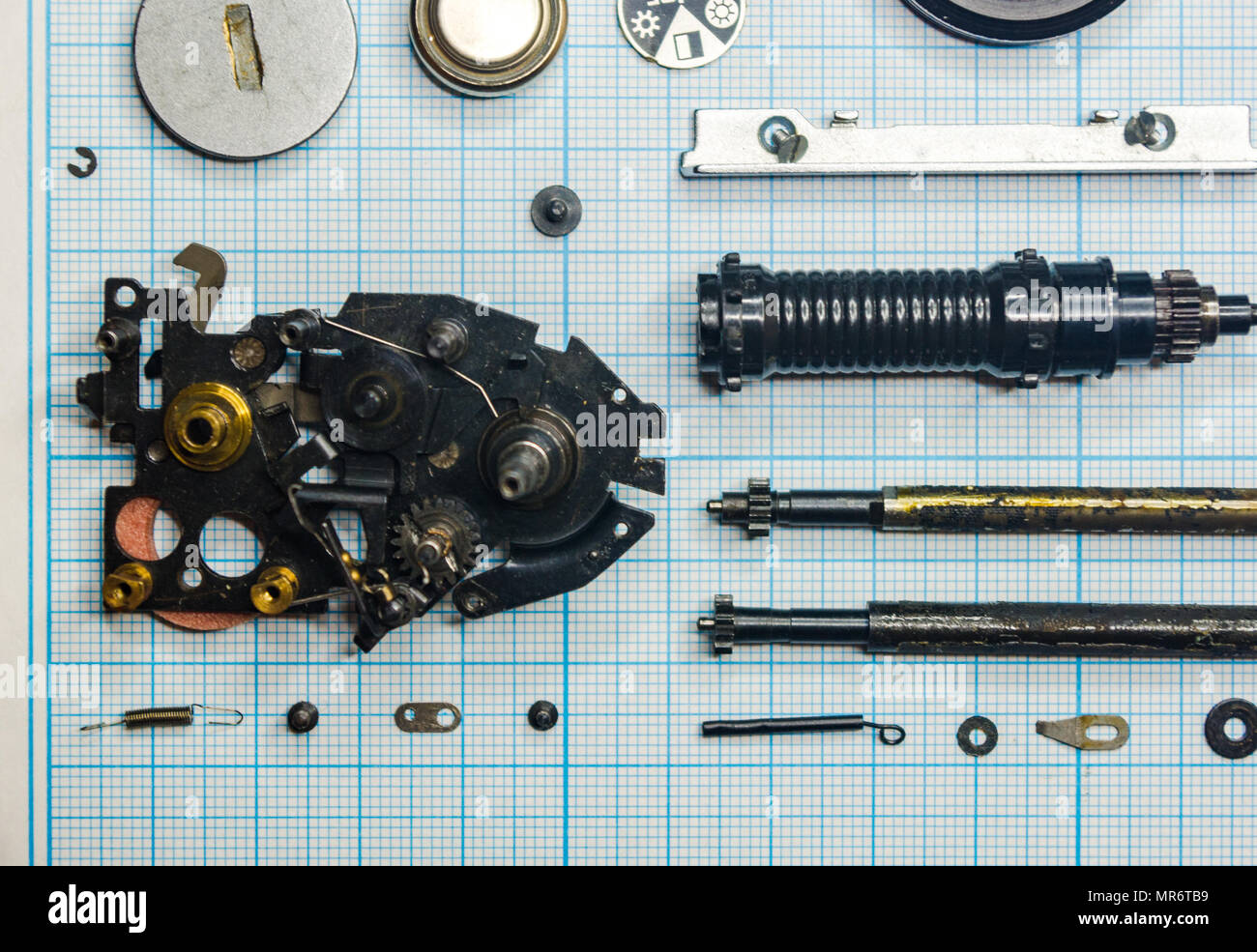 parts are completely disassembled old retro film SLR camera on graph ...