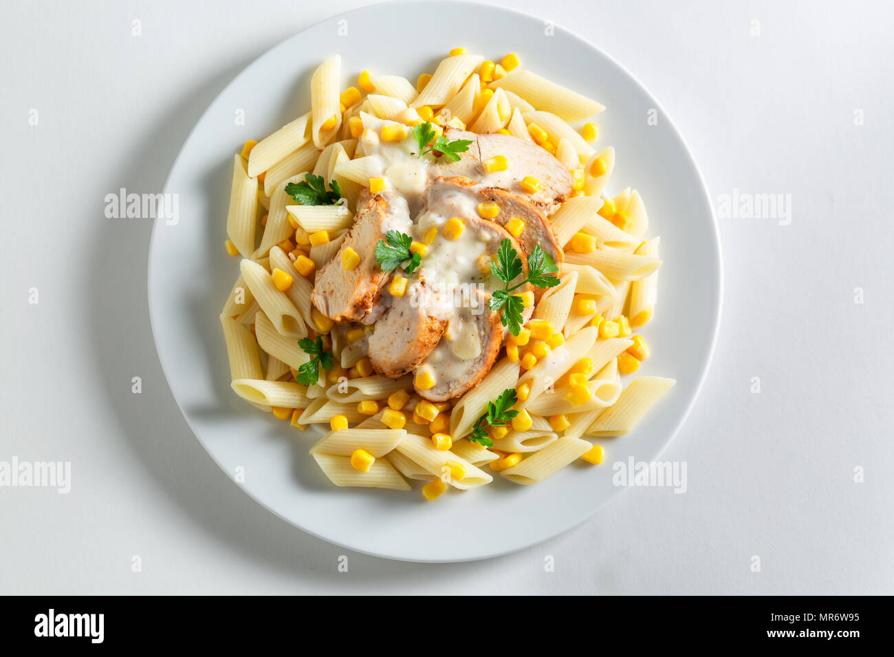 Delicious penne with bechamel sauce, chicken and corn Stock Photo - Alamy