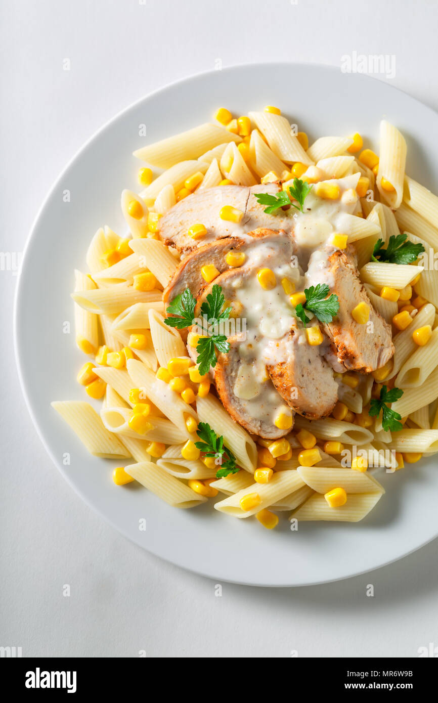 Tasty penne with bechamel sauce, chicken and corn Stock Photo - Alamy