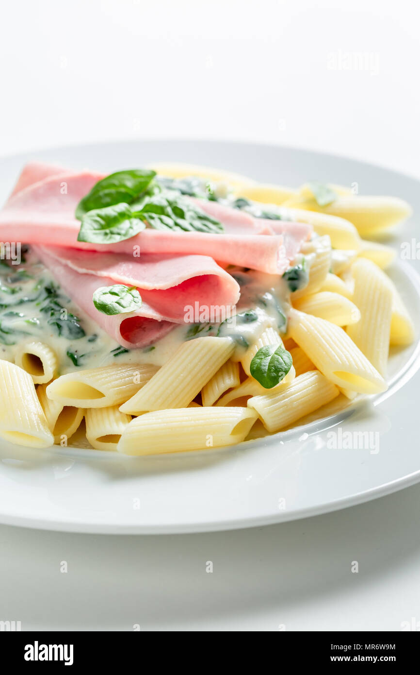 Tasty penne with spinach, ham and bechamel sauce Stock Photo - Alamy