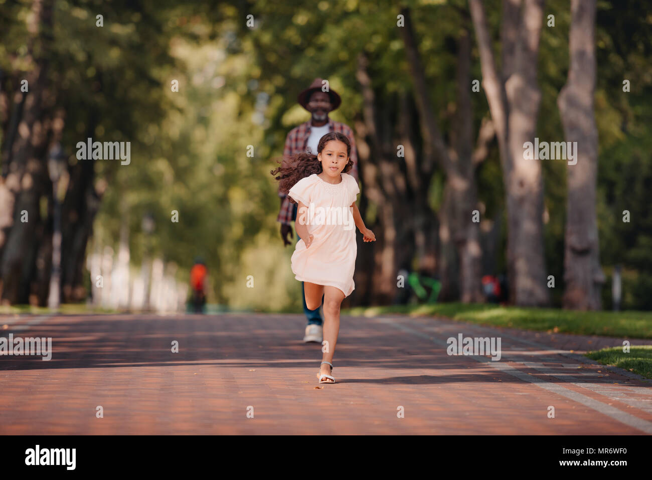 cute african american girl running and spending time with grandfather ...
