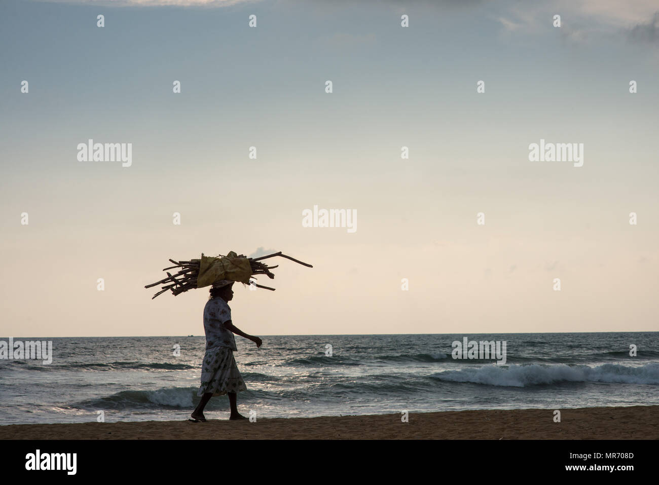 SRI LANKA - OCTOBER 26, 2017: old woman walking by seashore while ...