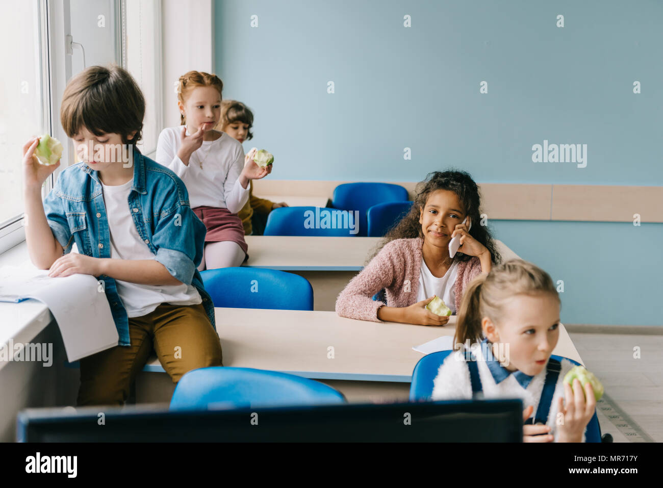classmates having break and relaxing at classroom Stock Photo - Alamy