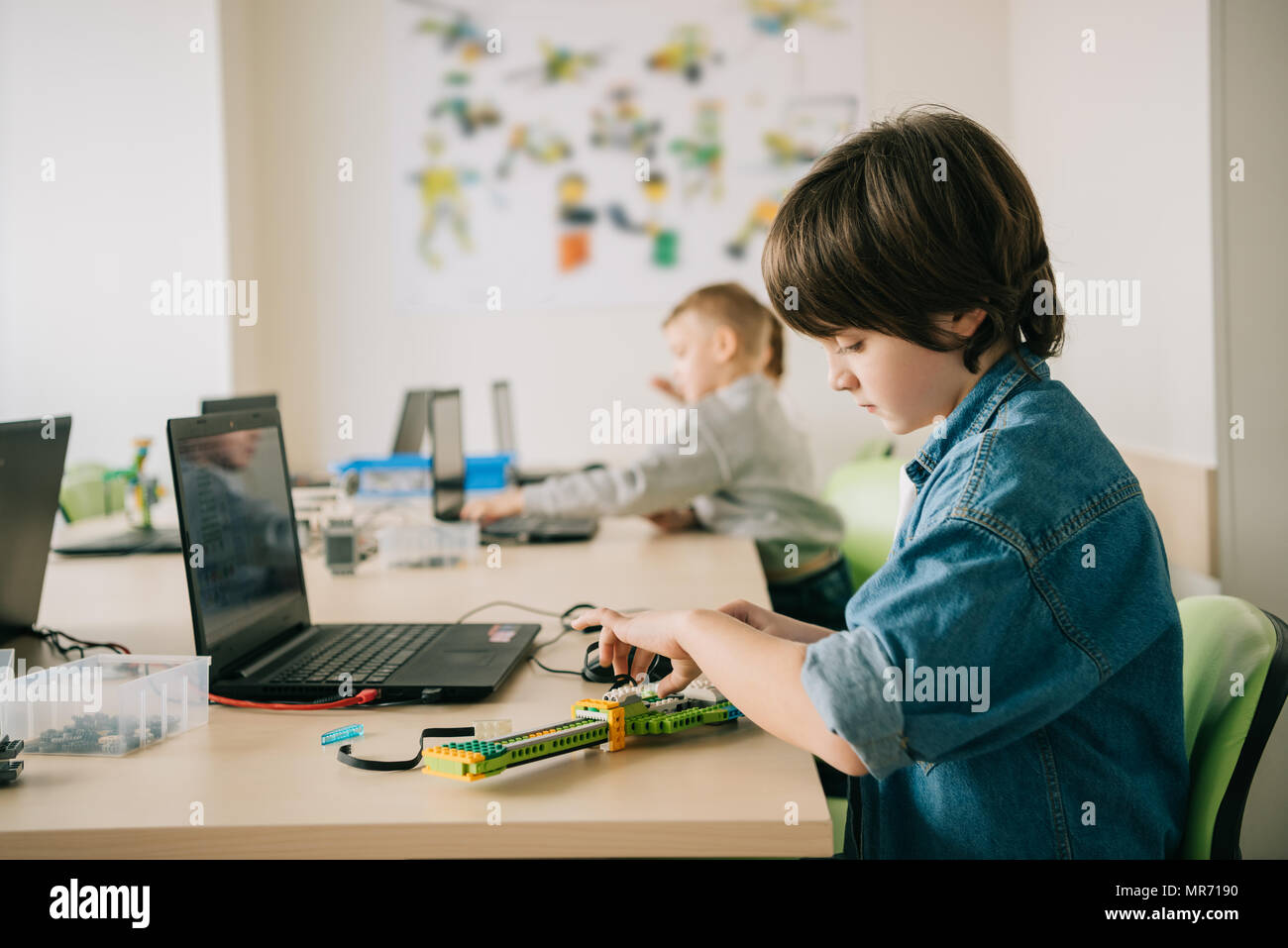 kid constructing robot at stem education class Stock Photo - Alamy
