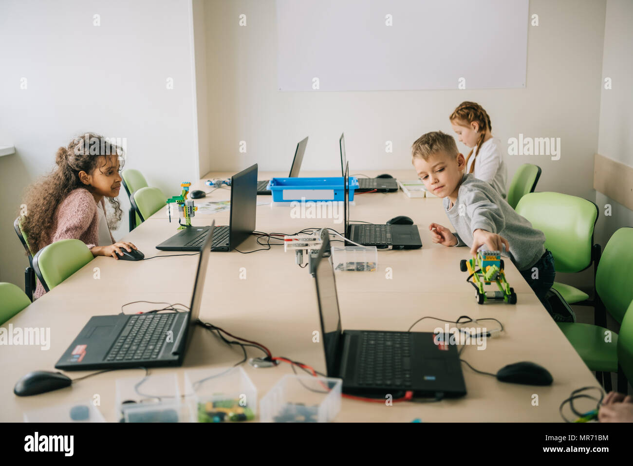 kids working on projects at machinery class Stock Photo - Alamy