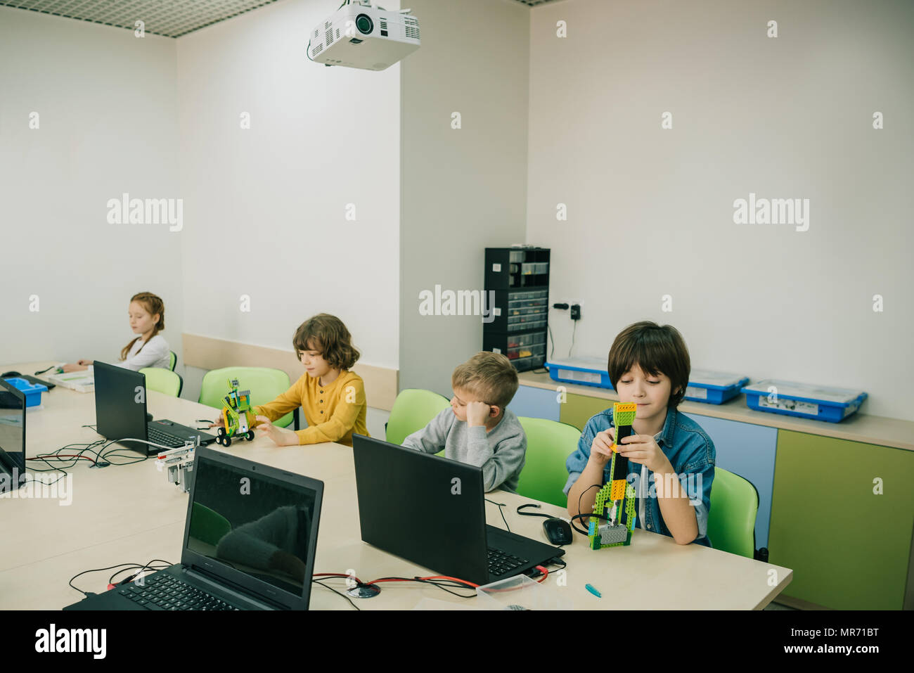 group of focused kids working on projects at stem education class Stock ...