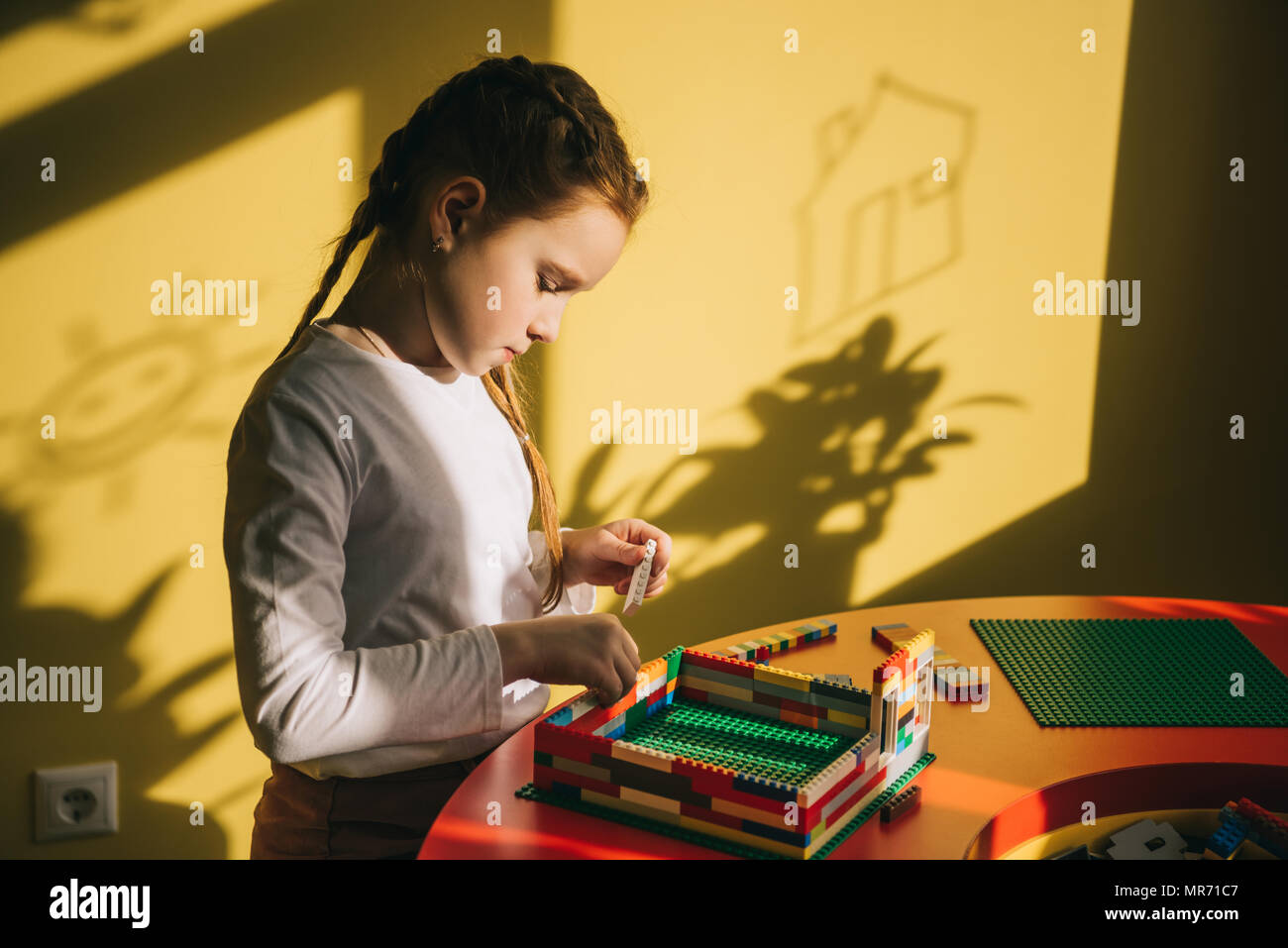 focused little child building house with constructor Stock Photo - Alamy
