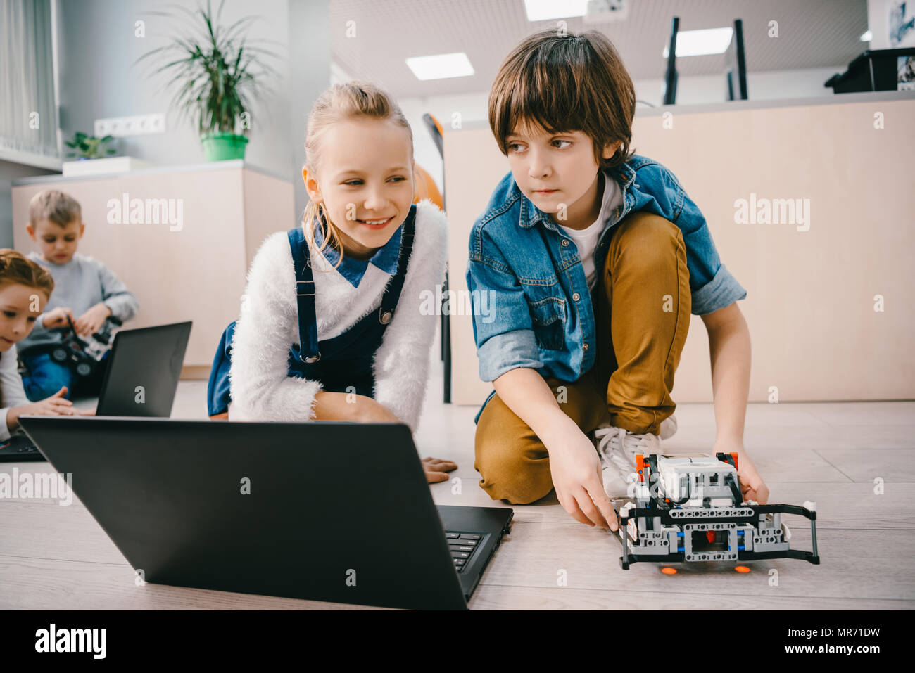kids programming robot on floor at machinery class Stock Photo - Alamy