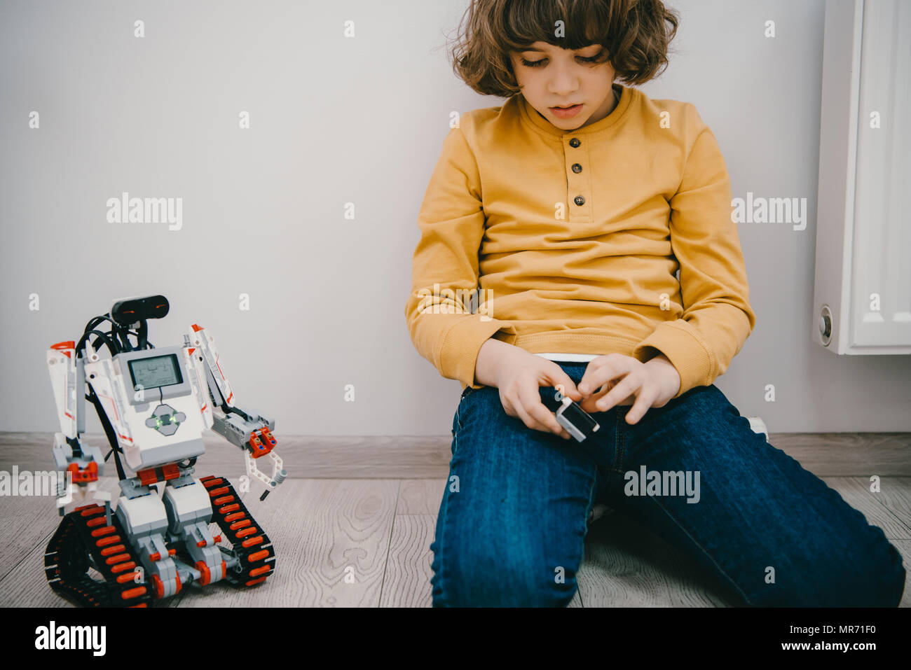 adorable little kid sitting on with diy robot Stock Photo - Alamy