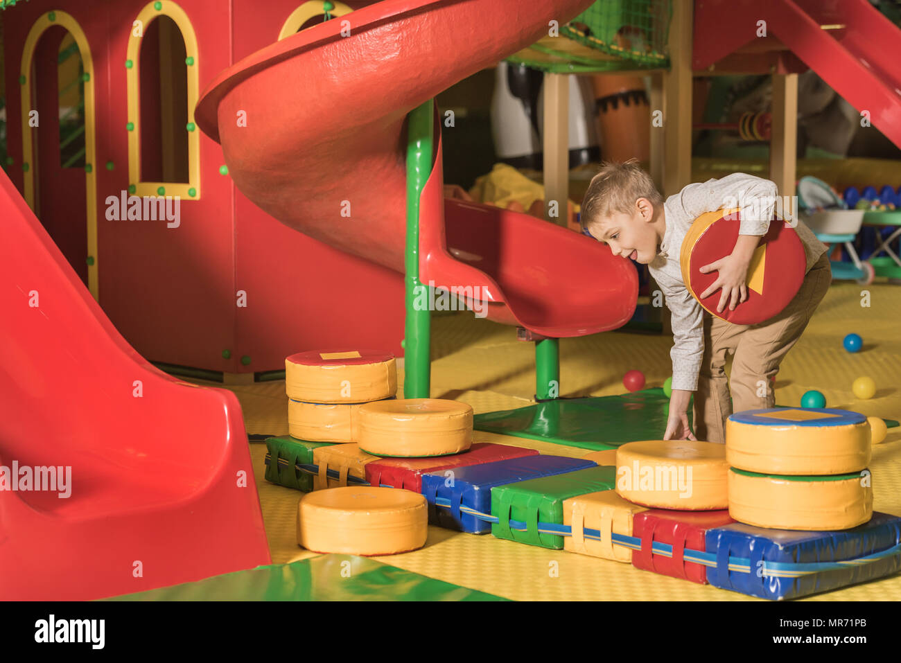 cute happy little boy playing with blocks in game center Stock Photo ...