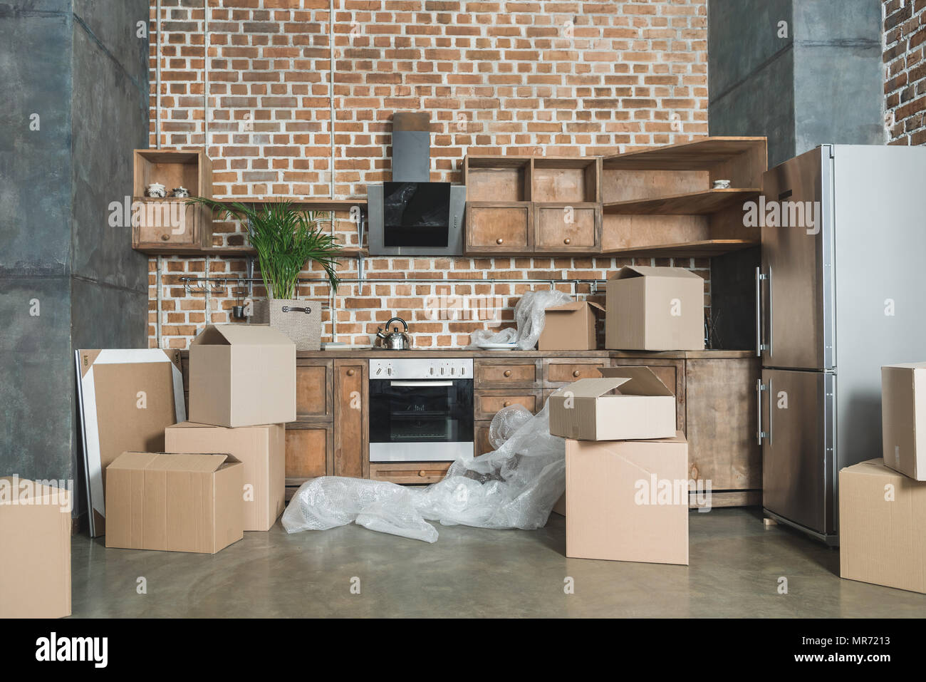 cardboard boxes in empty kitchen during relocation Stock Photo - Alamy