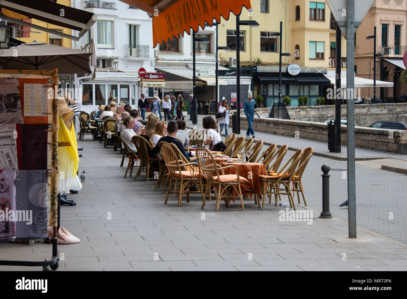 Tourists and residents dining outside a local cafe in Palamos on the ...