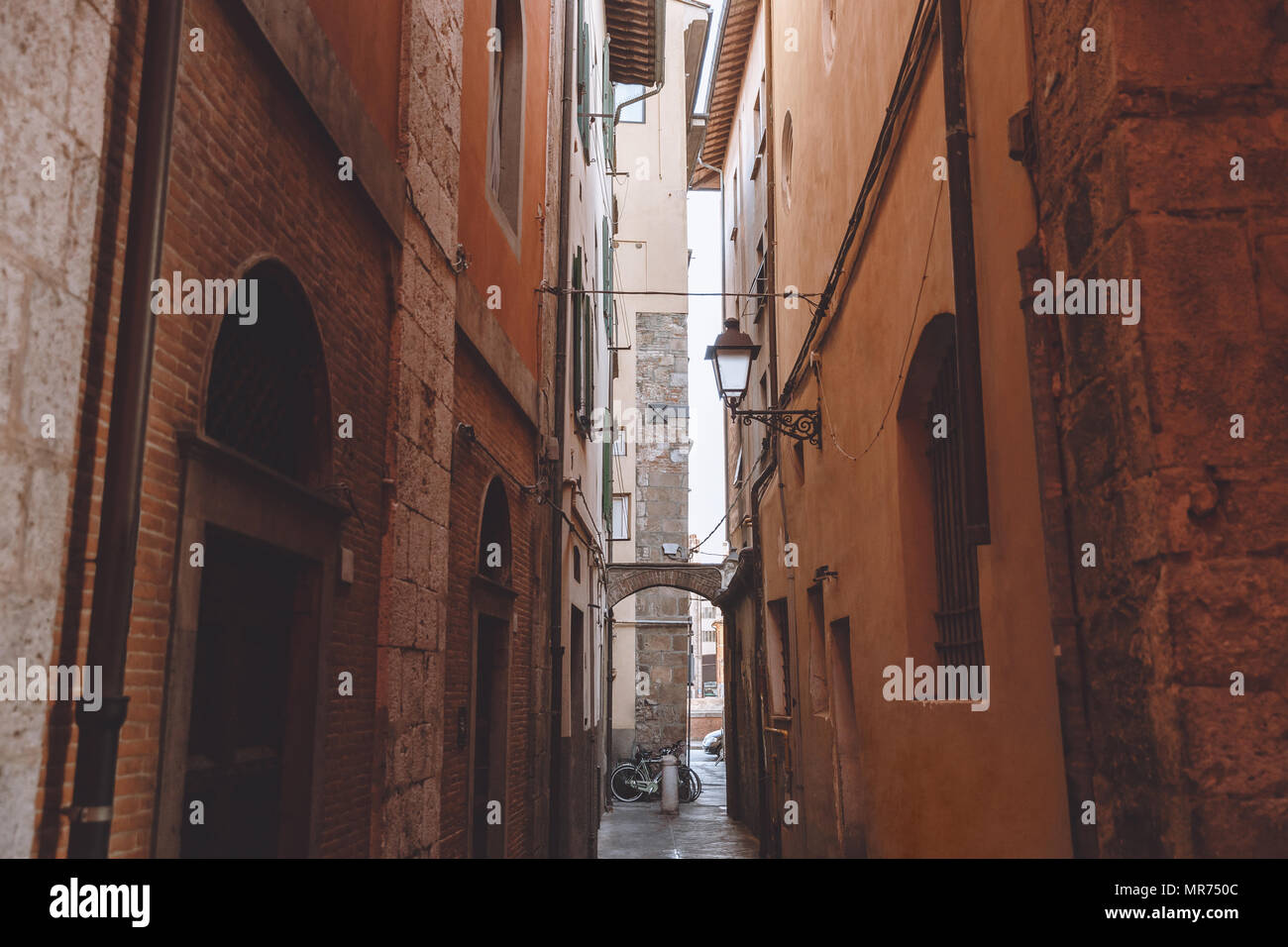 narrow alley between buildings in old city, Pisa, Italy Stock Photo - Alamy