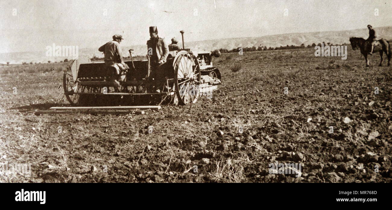 Jewish farmers plough a field with a tractor, in the Beit Shean Valley ...
