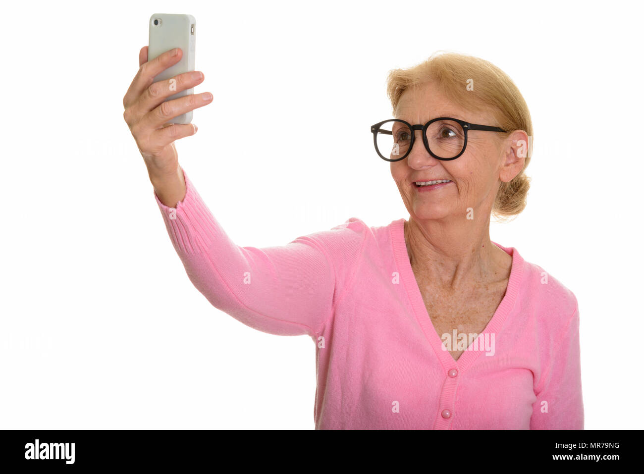 Happy senior nerd woman smiling and taking selfie with mobile ph Stock ...