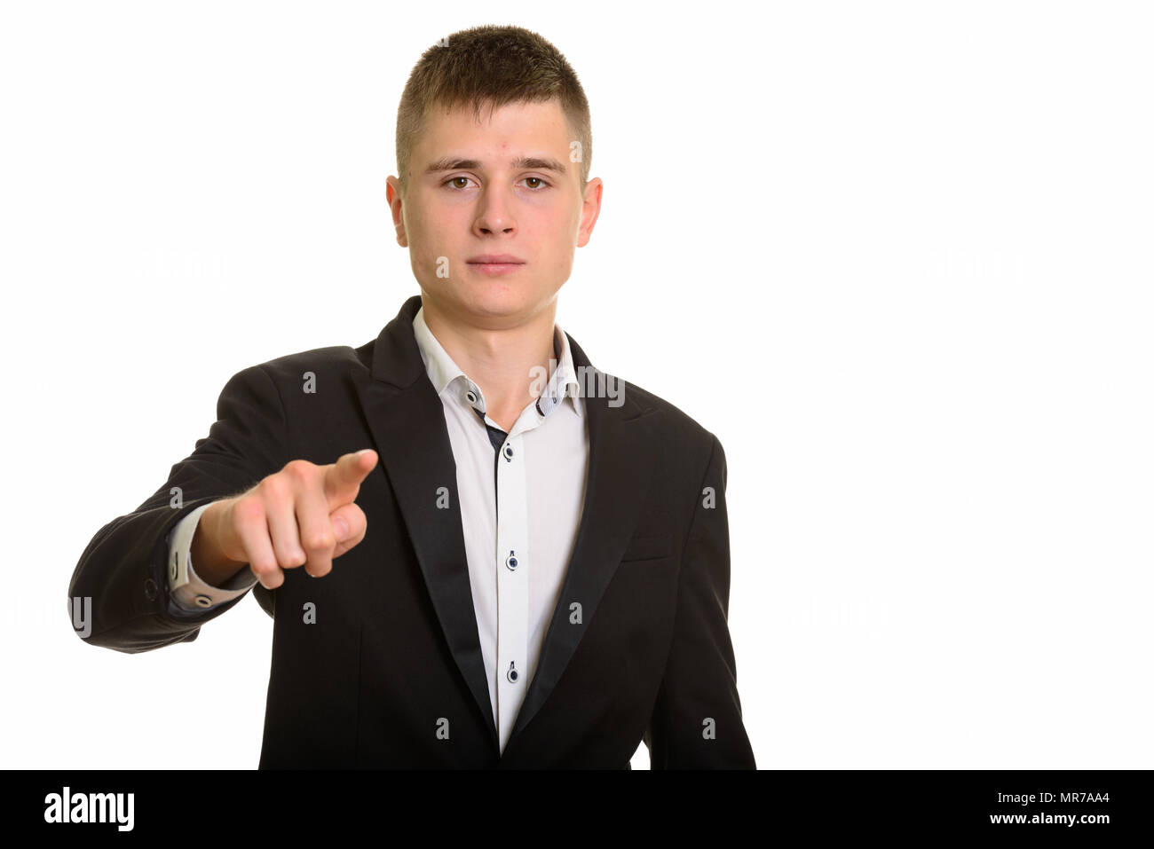 Studio shot of young businessman pointing finger at camera Stock Photo ...
