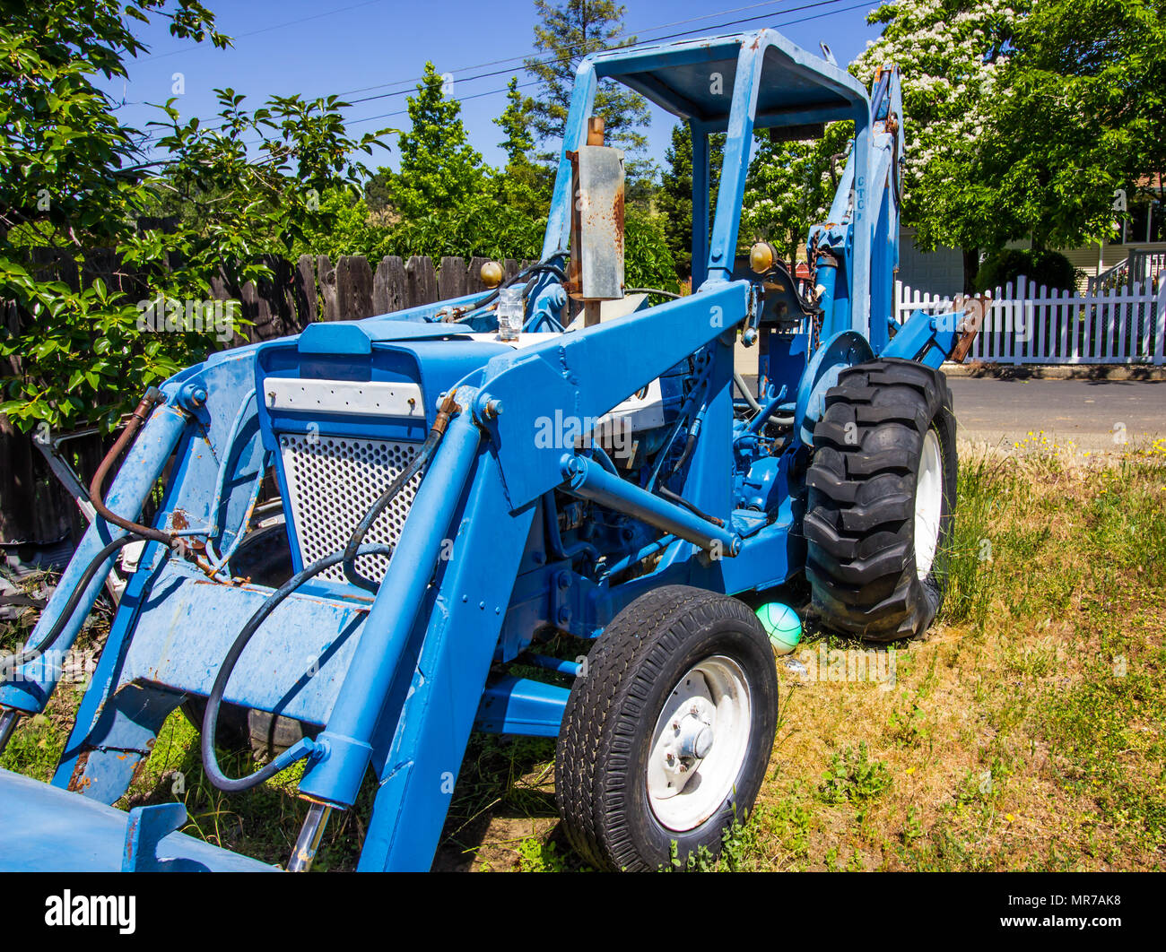 Blue Tractor With Backhoe Stock Photo - Alamy