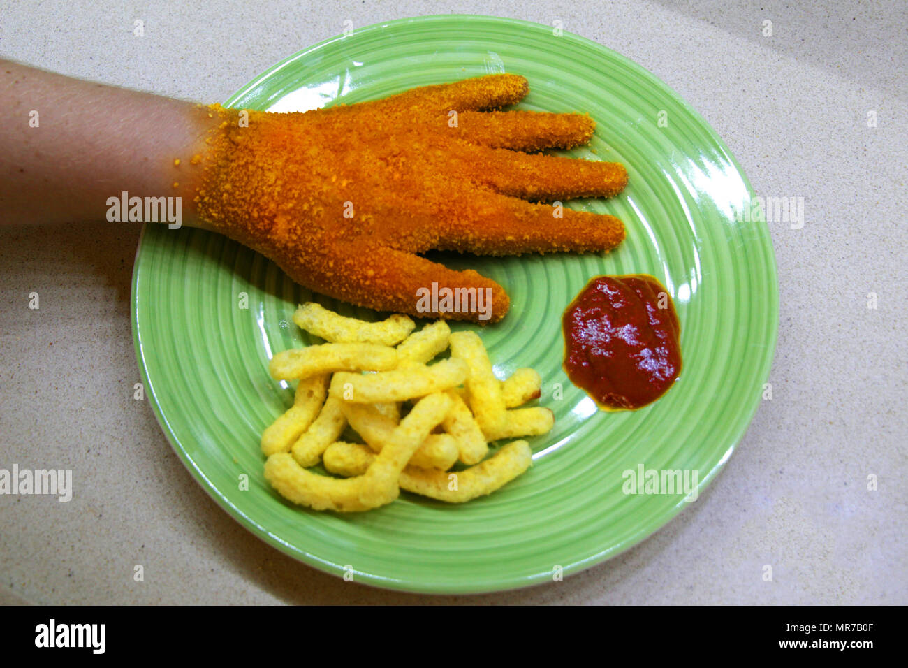 Hand covered with fried bread crumbs (crispy appearance looks like ...