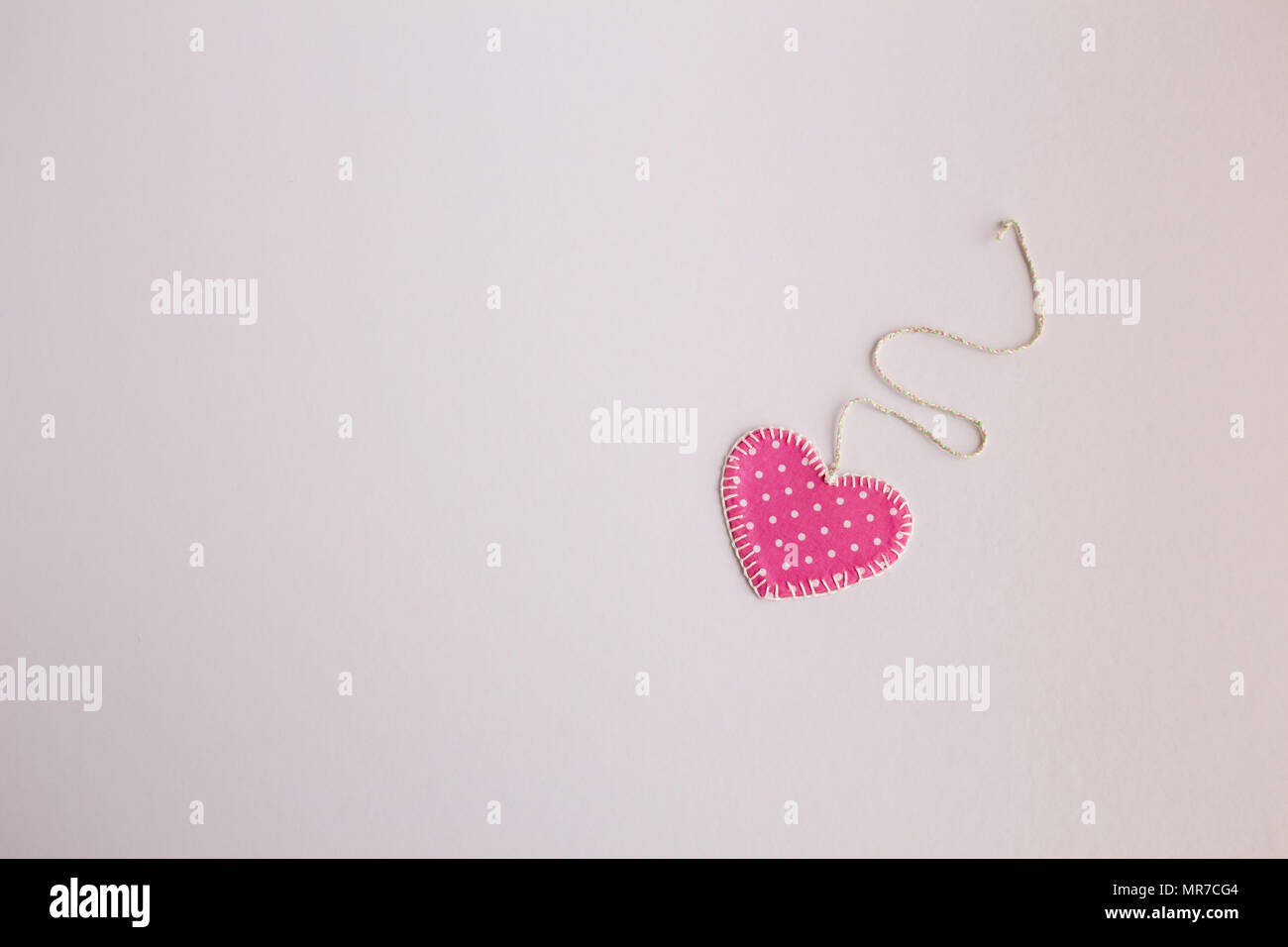Heart-shaped cloth patch on white background Stock Photo - Alamy