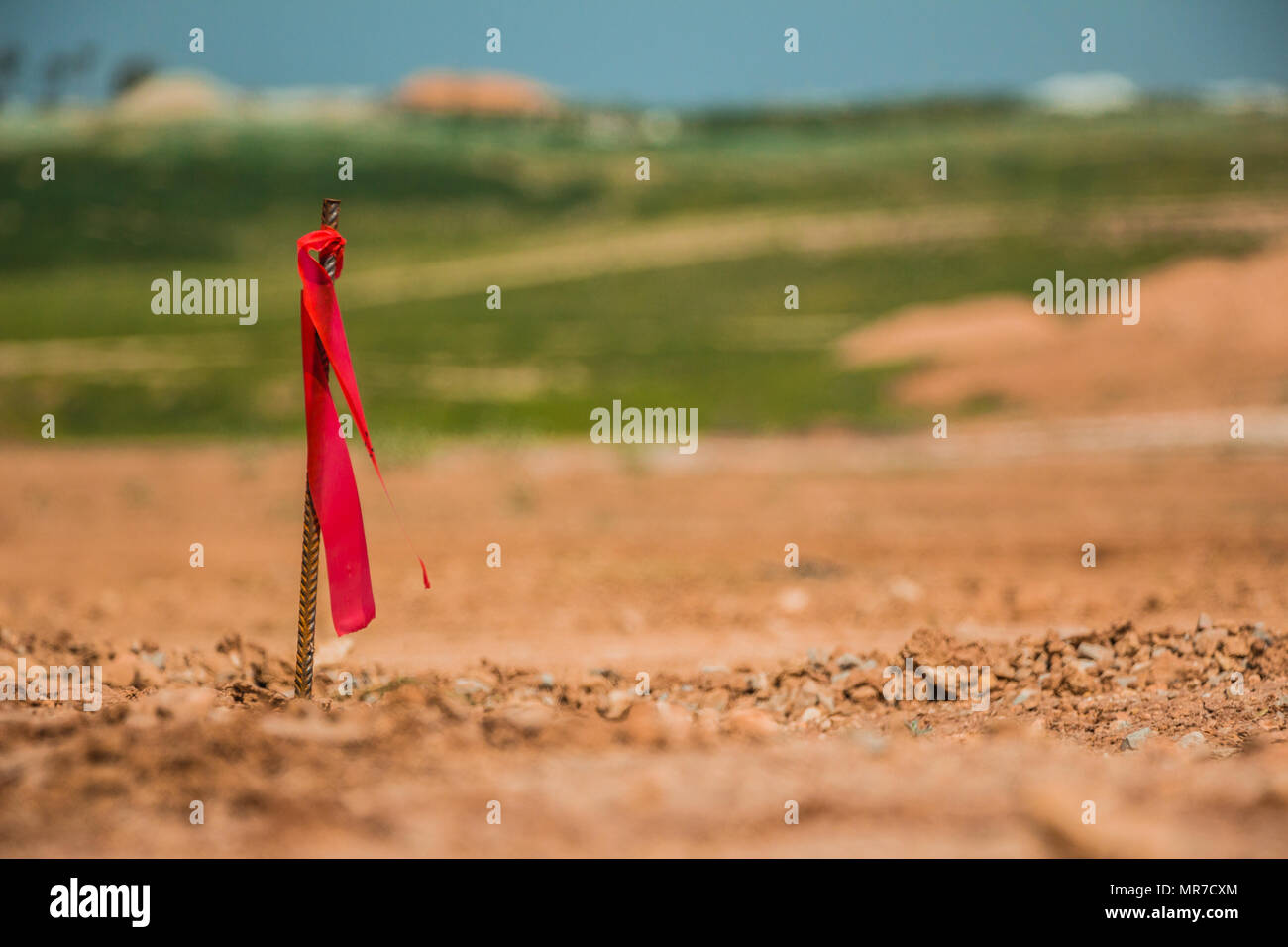 Metal survey peg with red flag on construction site Stock Photo - Alamy