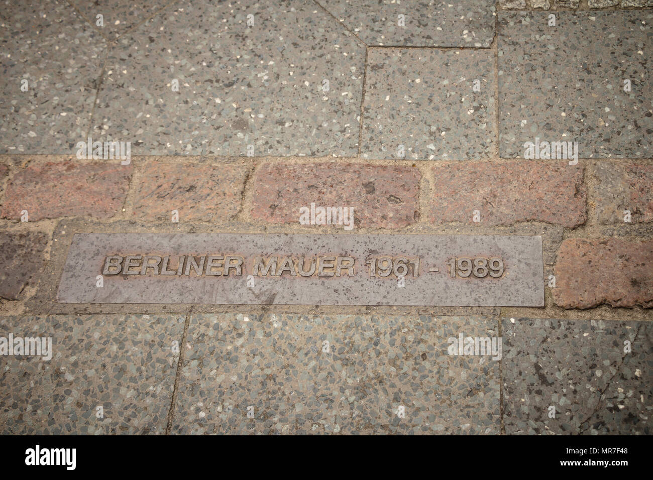 Berlin wall sign in the sidewalk which indicates the place of the ...