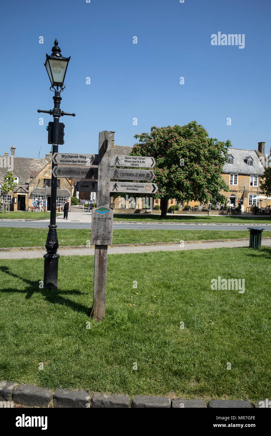 A wooden direction sign in the centre of Broadway, in the Cotswolds ...