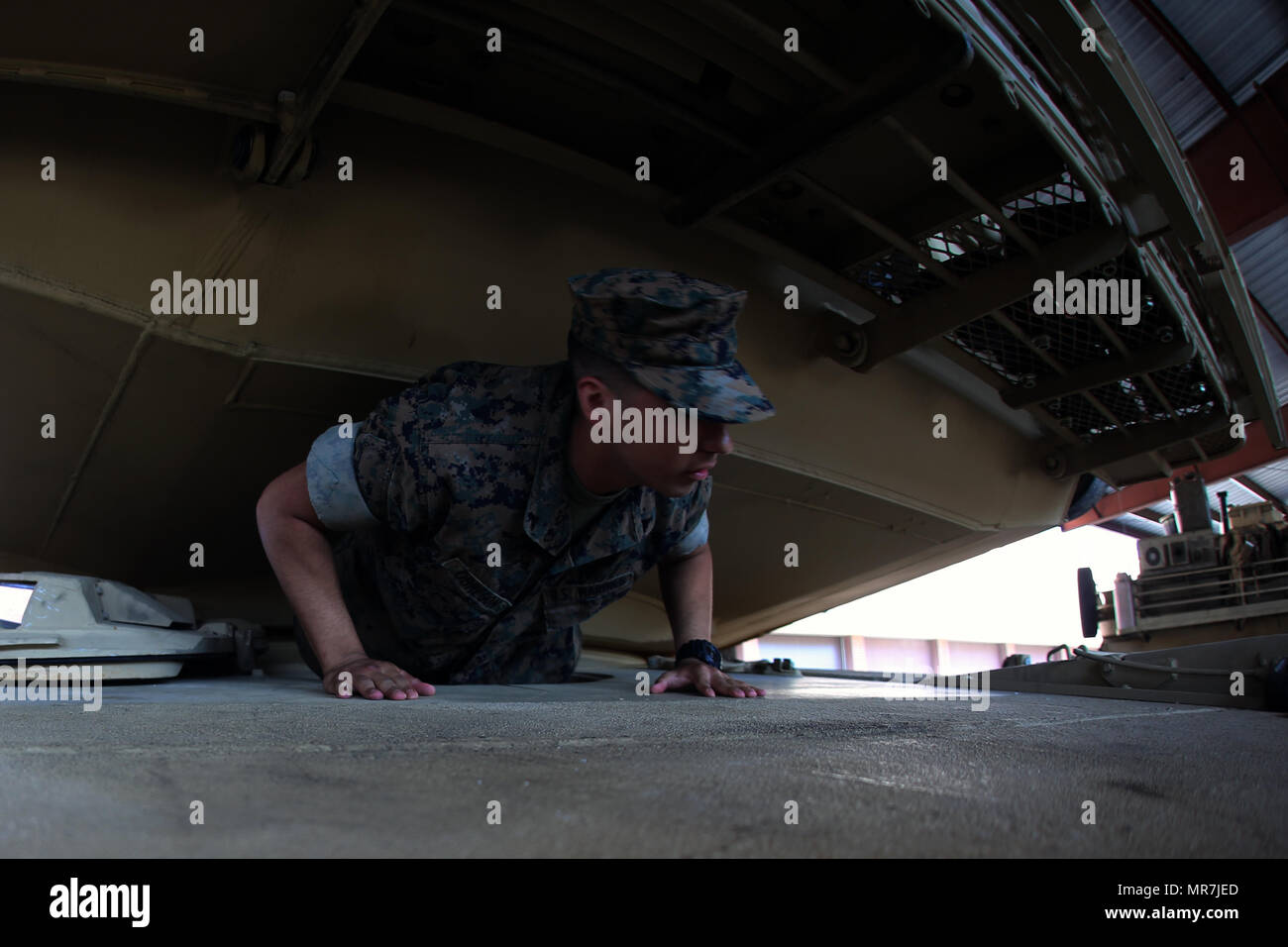 Lance Cpl. Cyrus Obregon climbs through the driver’s hole of an M1A1 ...