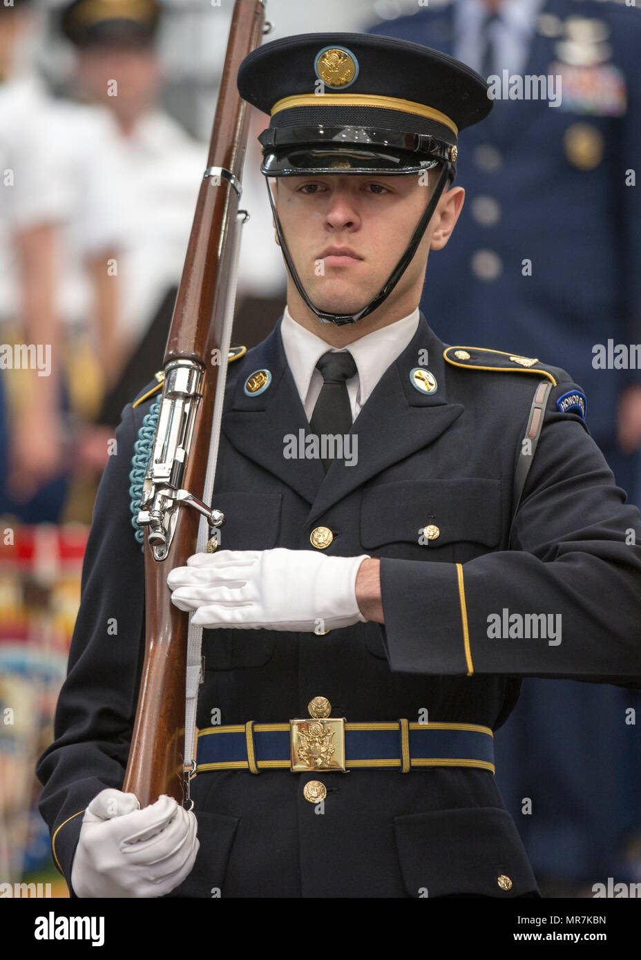 A member of the U.S. Armed Forces Color Guard presents the colors ...