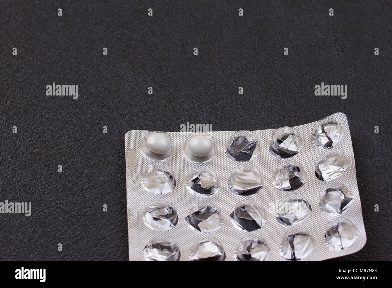 Plateau of black pills on the black background Stock Photo - Alamy
