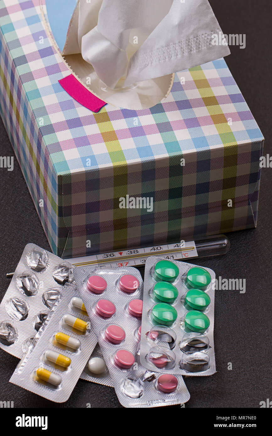 pills, thermometer, paper napkin and crumpled napkin on it. Top view ...