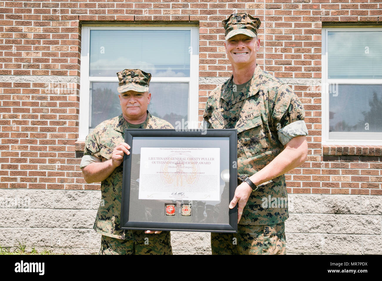 U.S. Navy Capt. Brian Tolbert, right, commanding officer, 2nd Medical ...