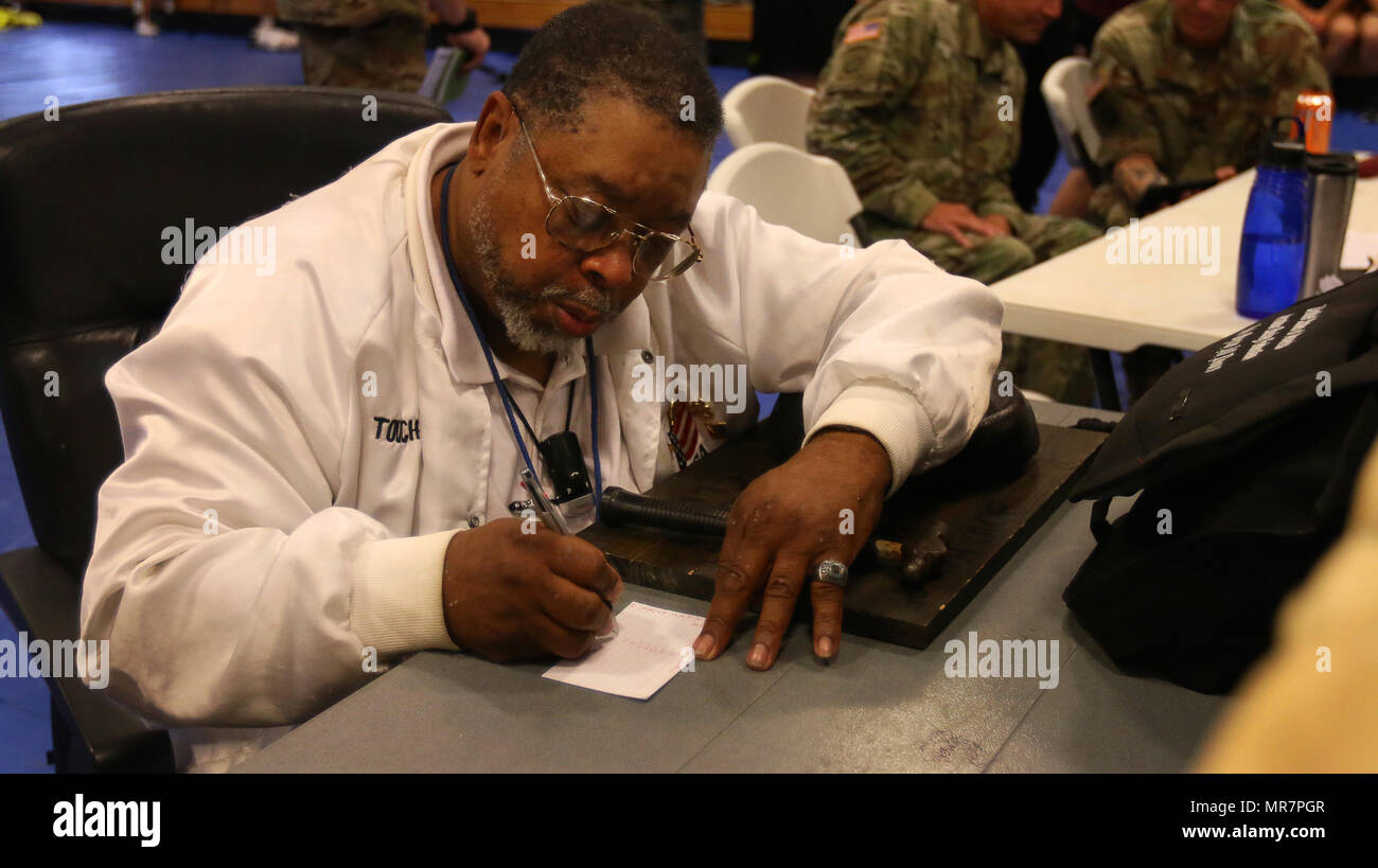 A judge takes the time to tally the scores of the boxing match during ...