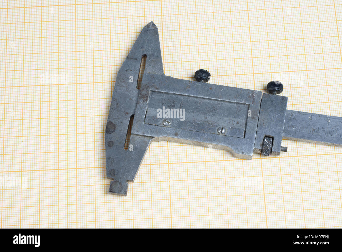 caliper on graph paper background Stock Photo - Alamy
